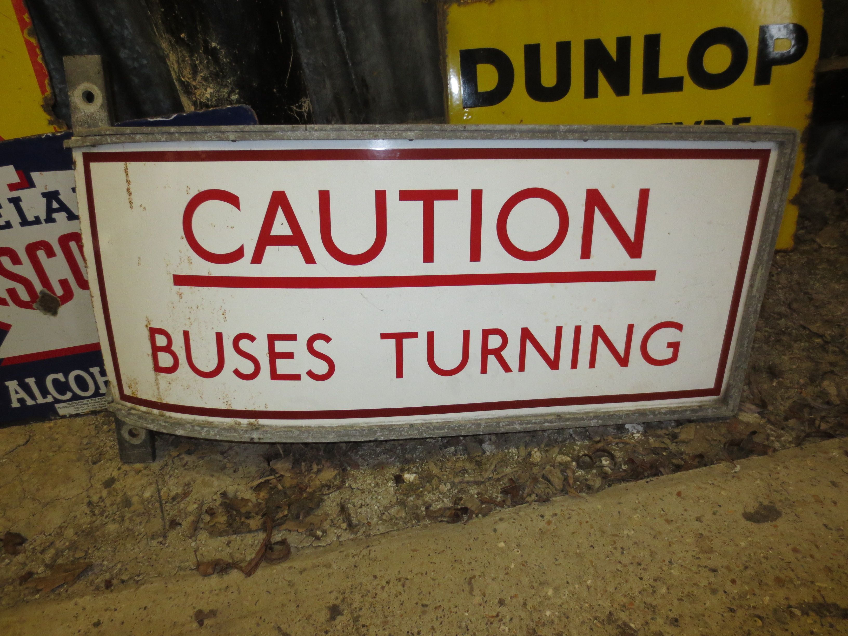 Bonhams Cars : A 'Caution Buses Turning' enamel sign in a cast alloy frame,