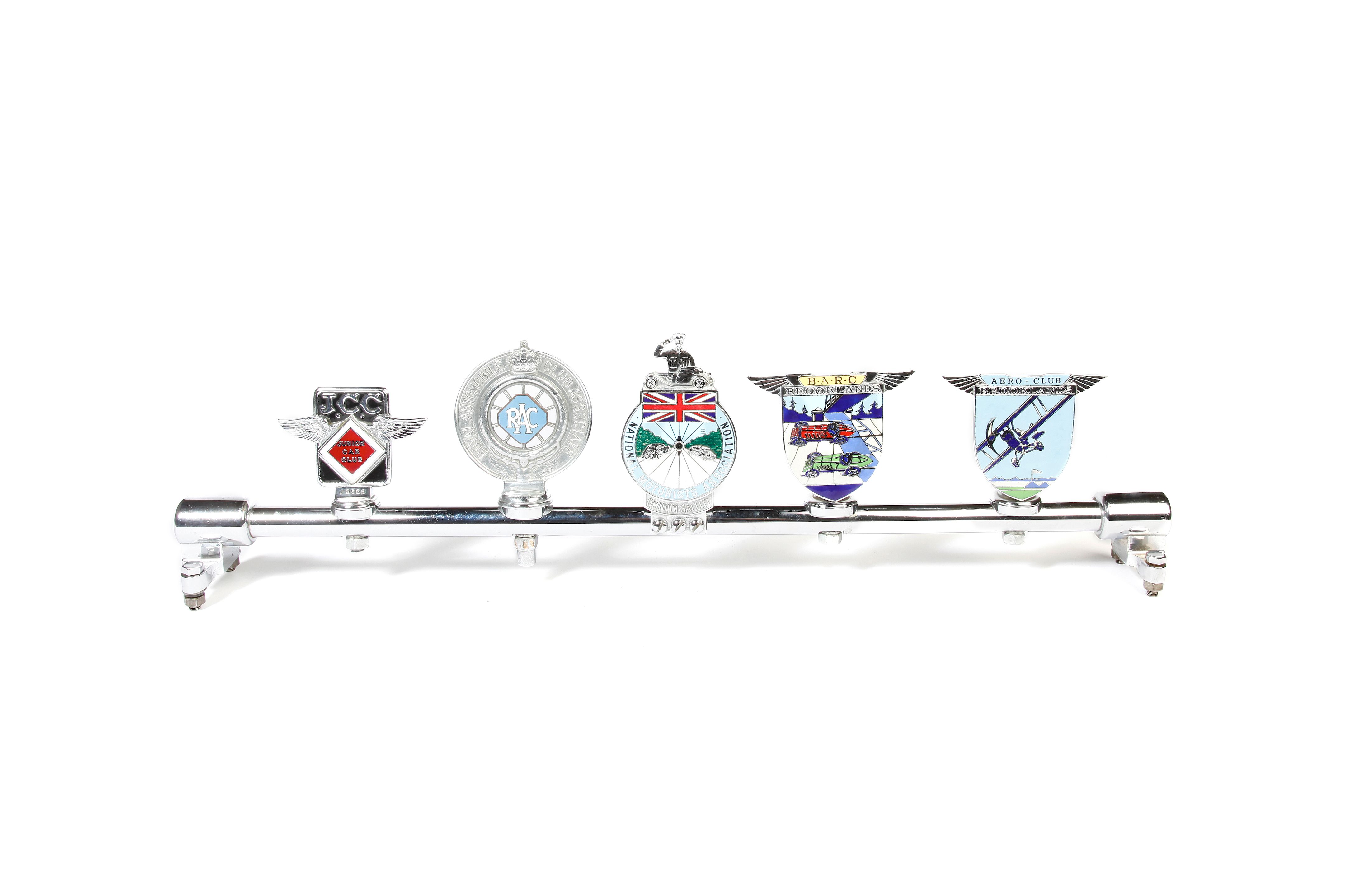Bonhams Cars : A good badge bar mounted with five enamel badges,