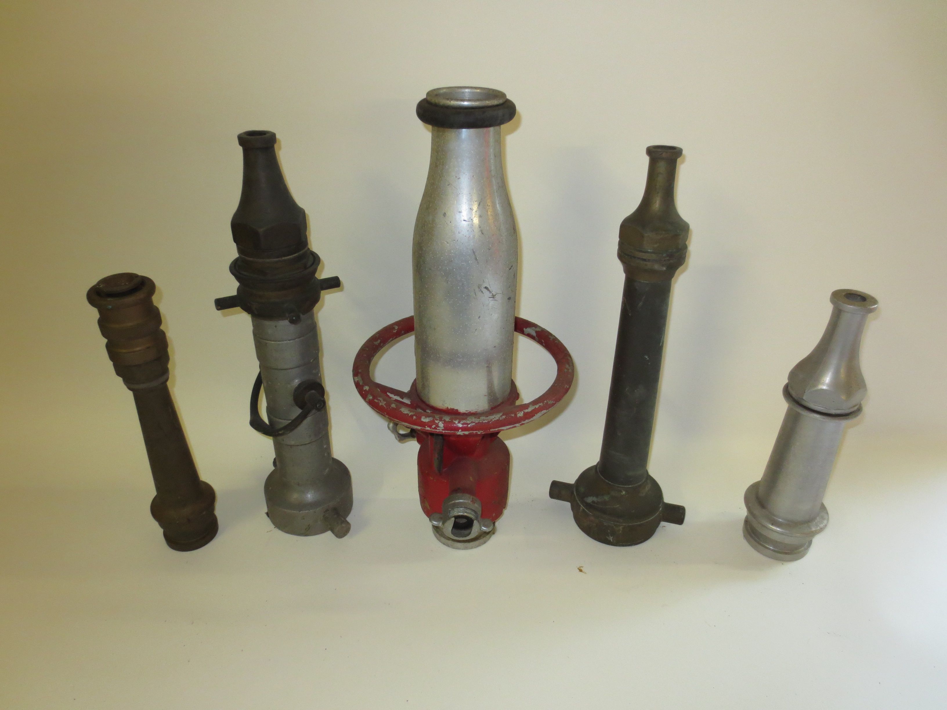 Bonhams Cars : Five assorted fire hose nozzles.