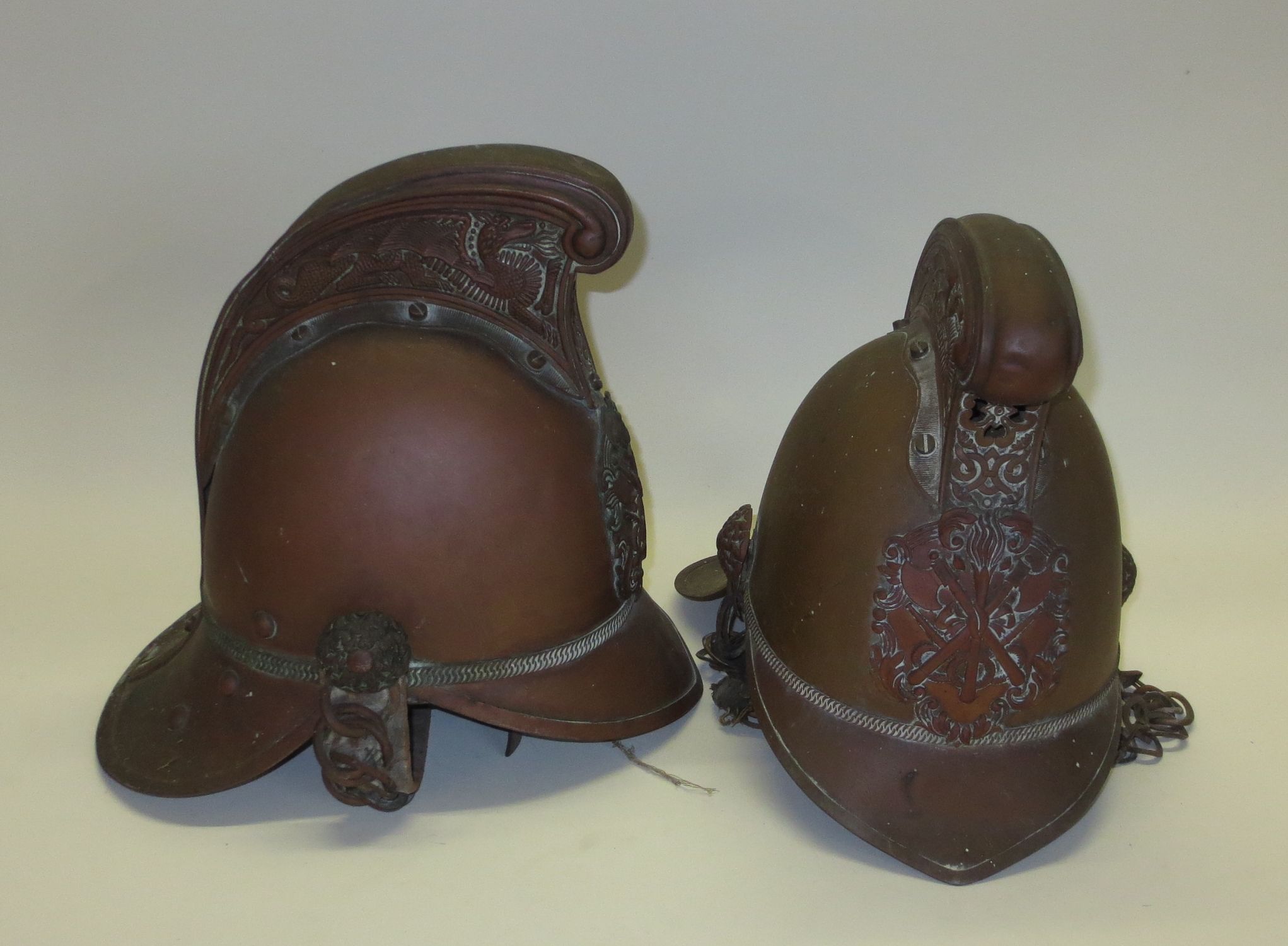 Bonhams Cars : Two traditional brass fireman's helmets,