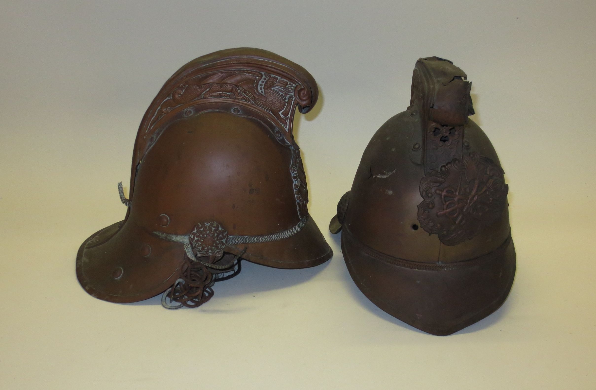 Bonhams Cars : Two traditional brass fireman's helmets,