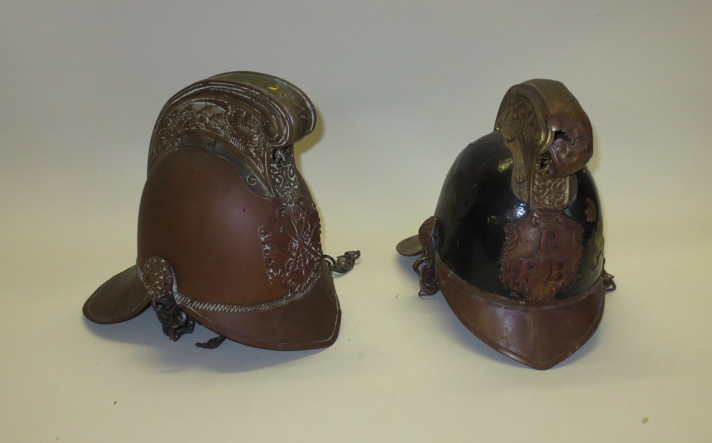 Bonhams Cars : Two traditional brass fireman's helmets,