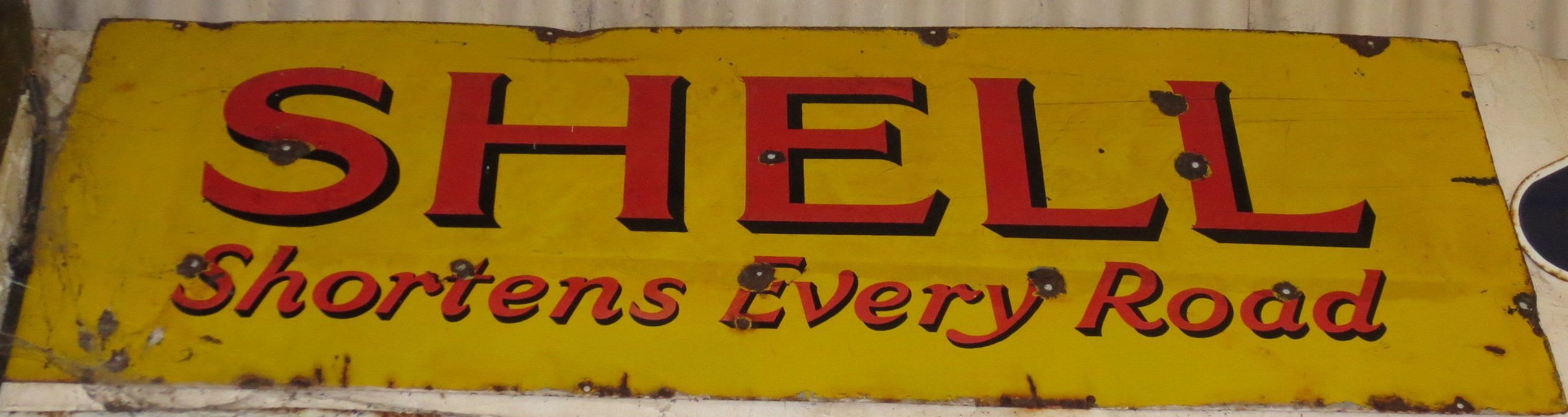 Bonhams Cars : A Shell 'Shortens every road' enamel sign,