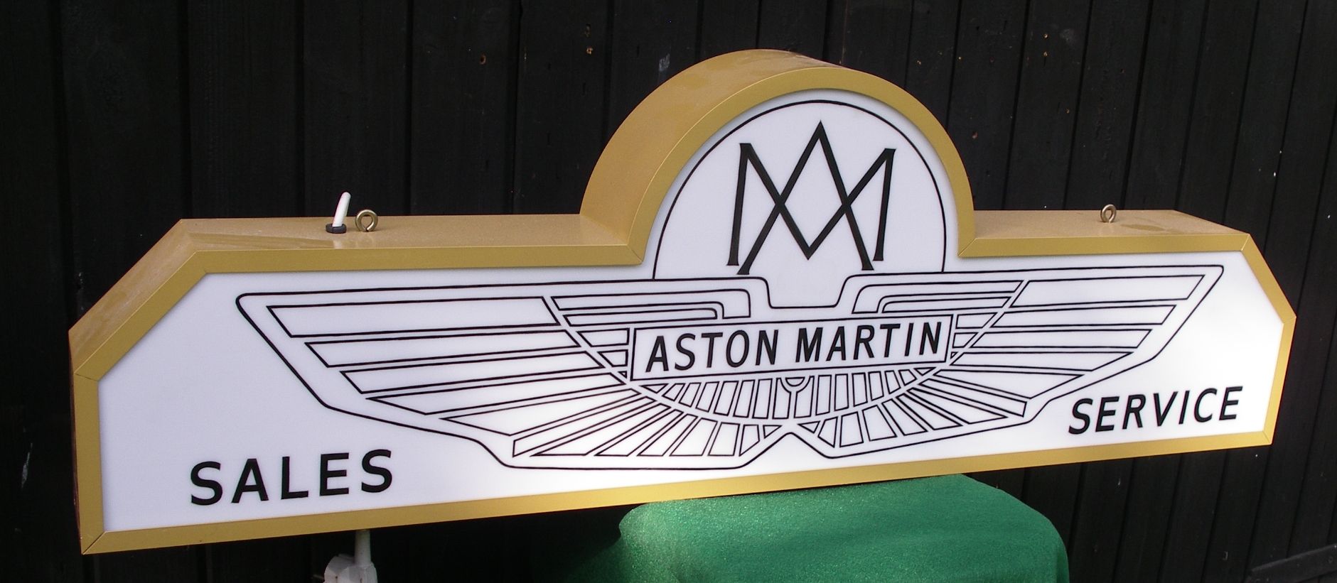 Bonhams Cars : An 'Aston Martin Sales & Service' illuminating sign,