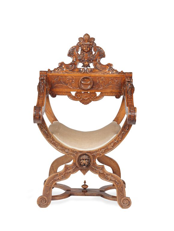 Bonhams : A 19th Century Italian carved walnut 'X' frame elbow chair