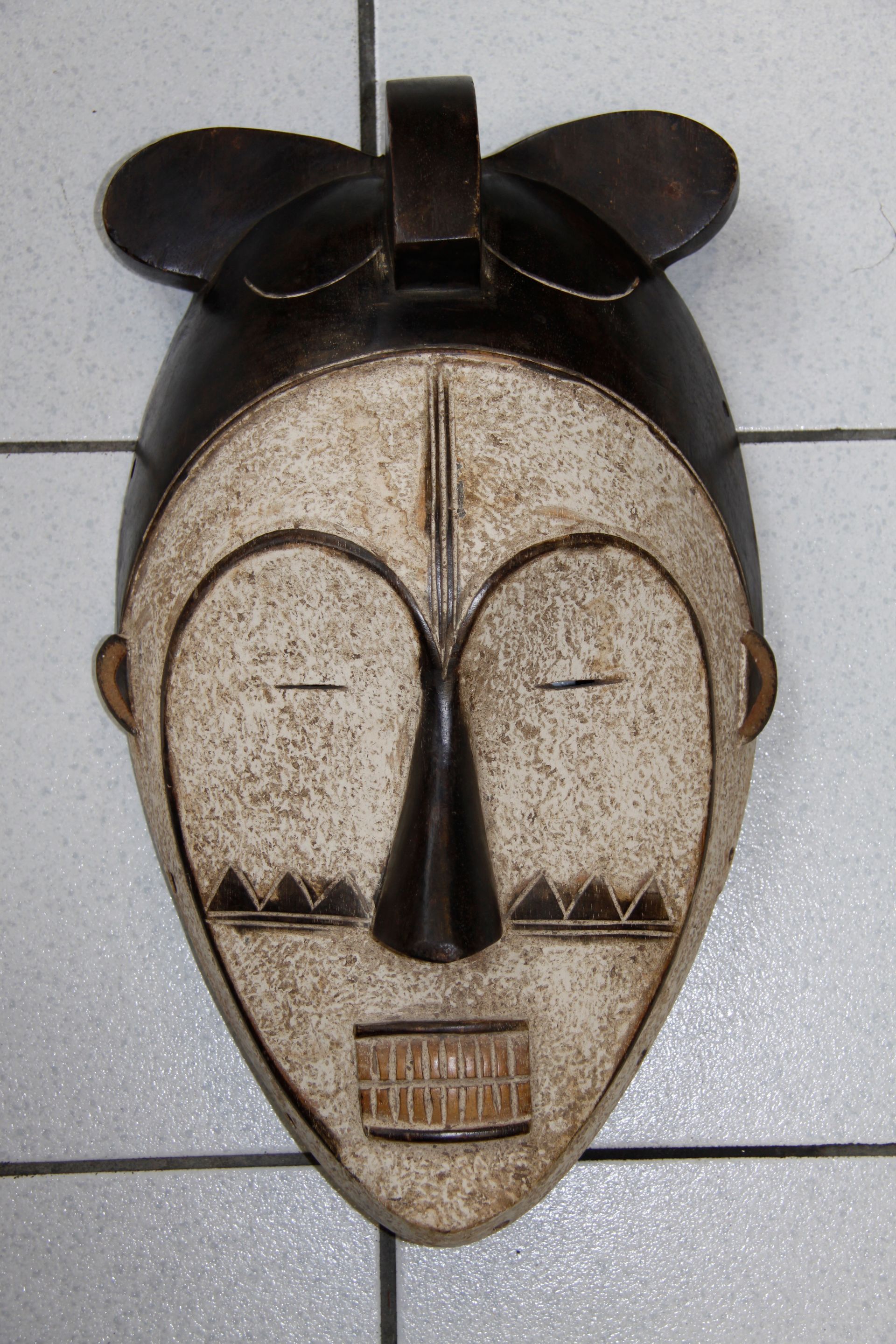 Bonhams : Two carved African masks,one with metal mounts,58cm & 48cm ...