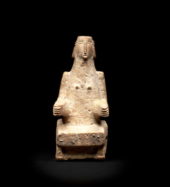 Bonhams : A South Arabian limestone seated female figure