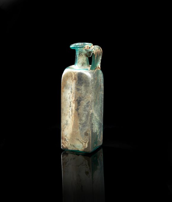 Bonhams : A Roman green glass prismatic bottle