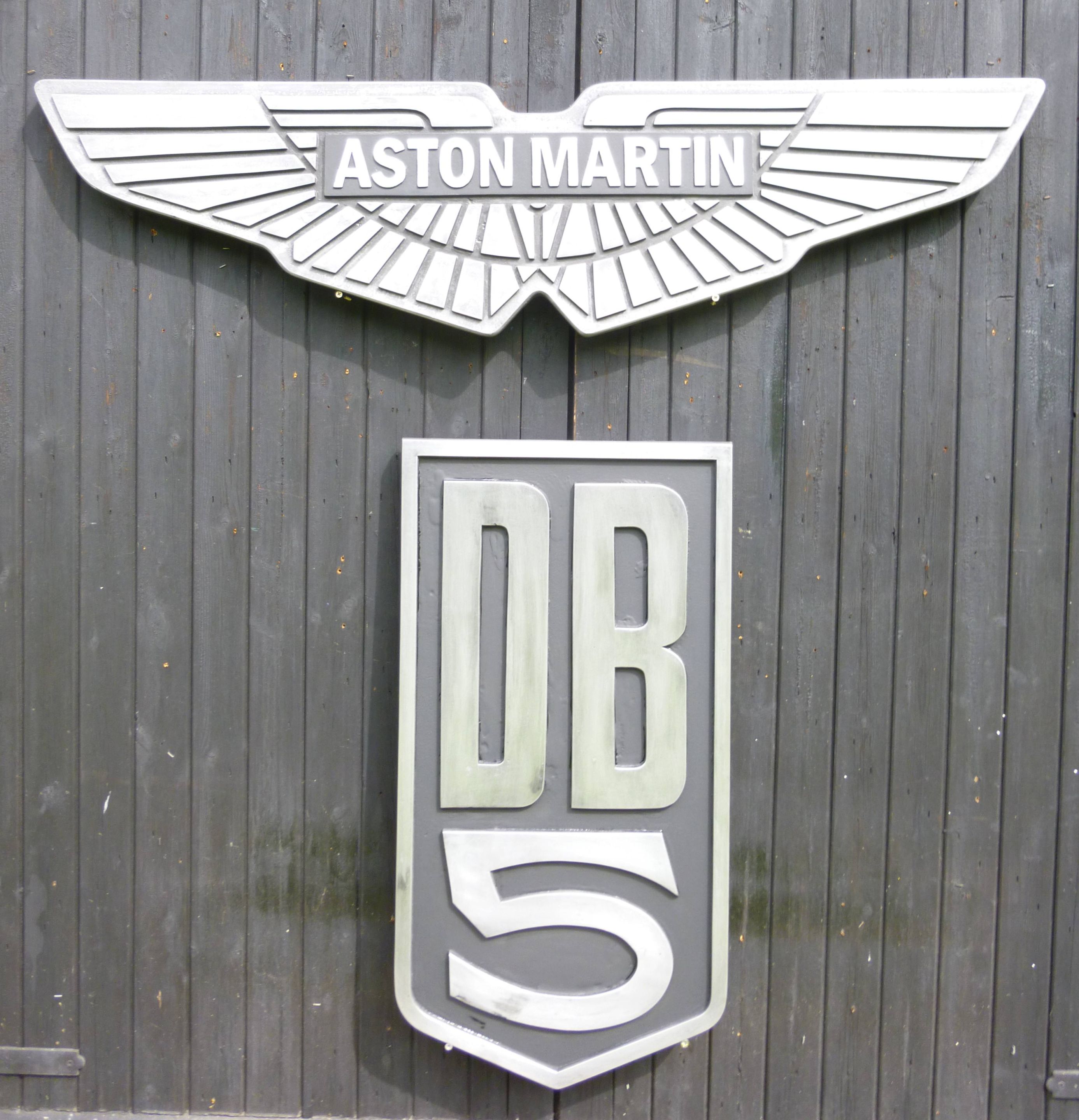 Bonhams Cars : Two garage display emblems for 'Aston Martin' and 'DB5',