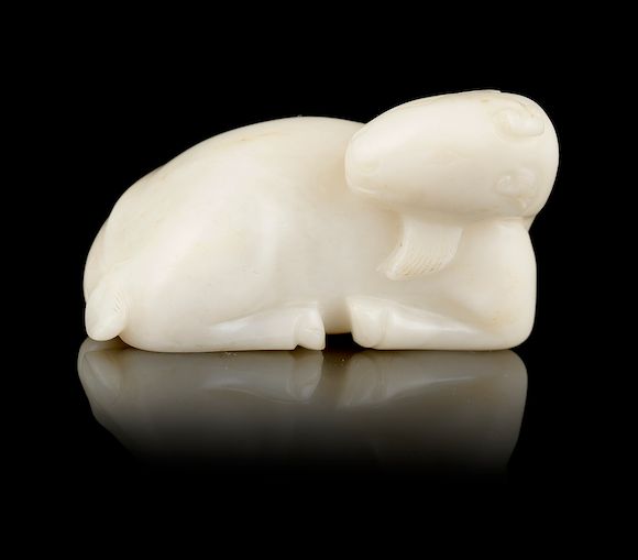 Bonhams : A mutton fat pebble jade carving of a recumbent goat Qing Dynasty