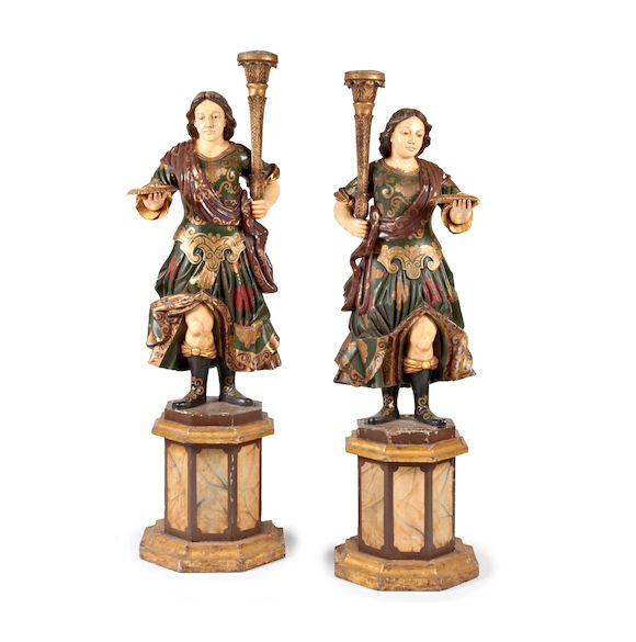 Bonhams : A pair of carved wood polychrome decorated figural torch bearers
