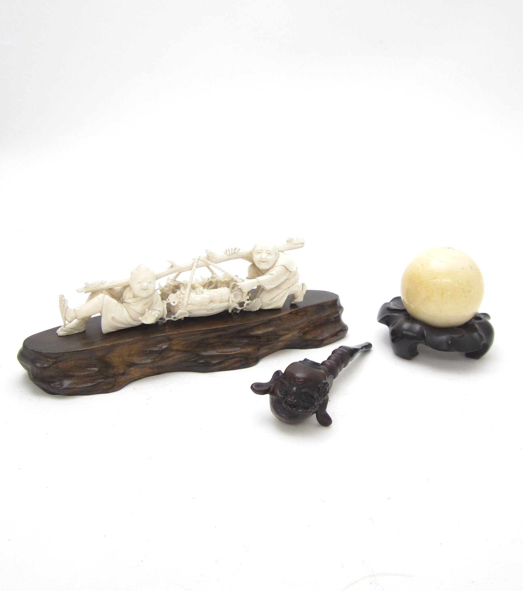 Bonhams : An ivory okimono, ivory sphere and a novelty pipe 19th century