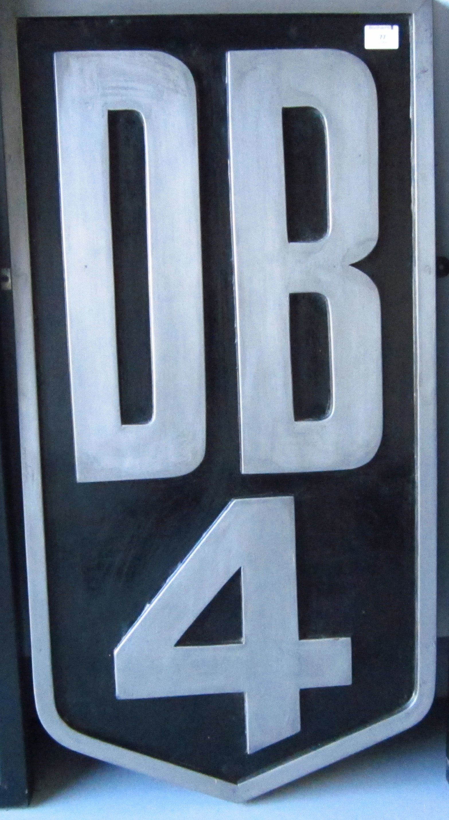 Bonhams Cars : A 'DB4' garage display emblem,
