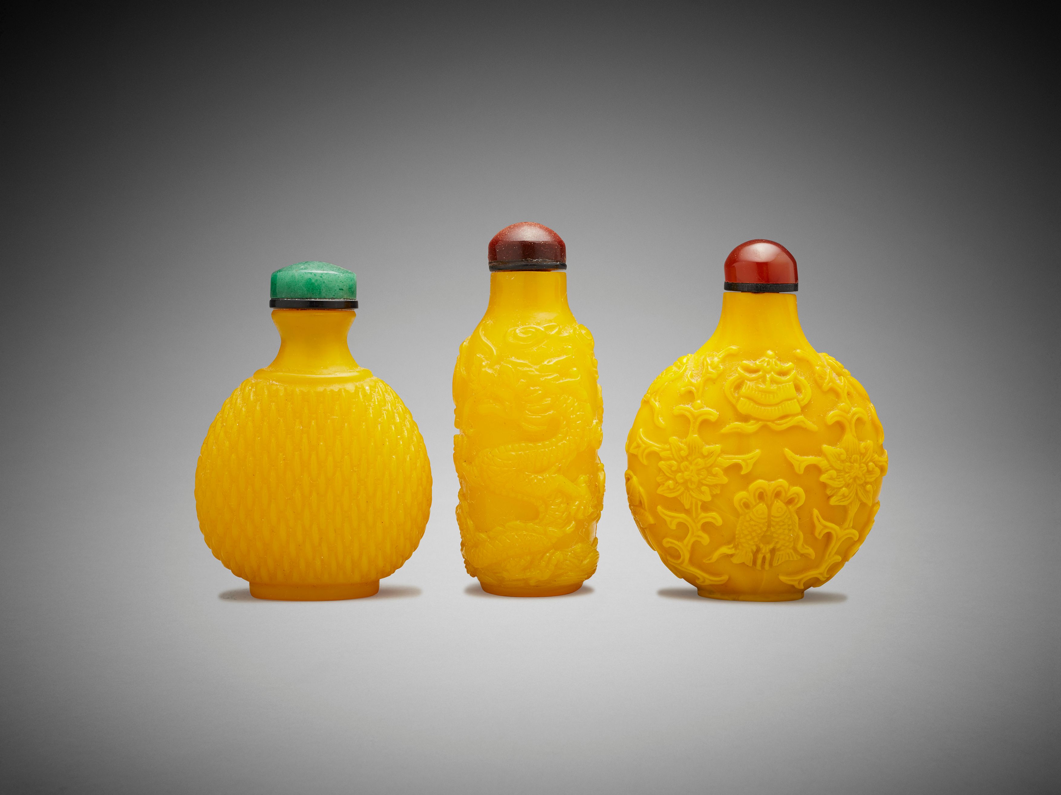 Bonhams : Three Chinese carved yellow-glass snuff bottles 20th Century (3)