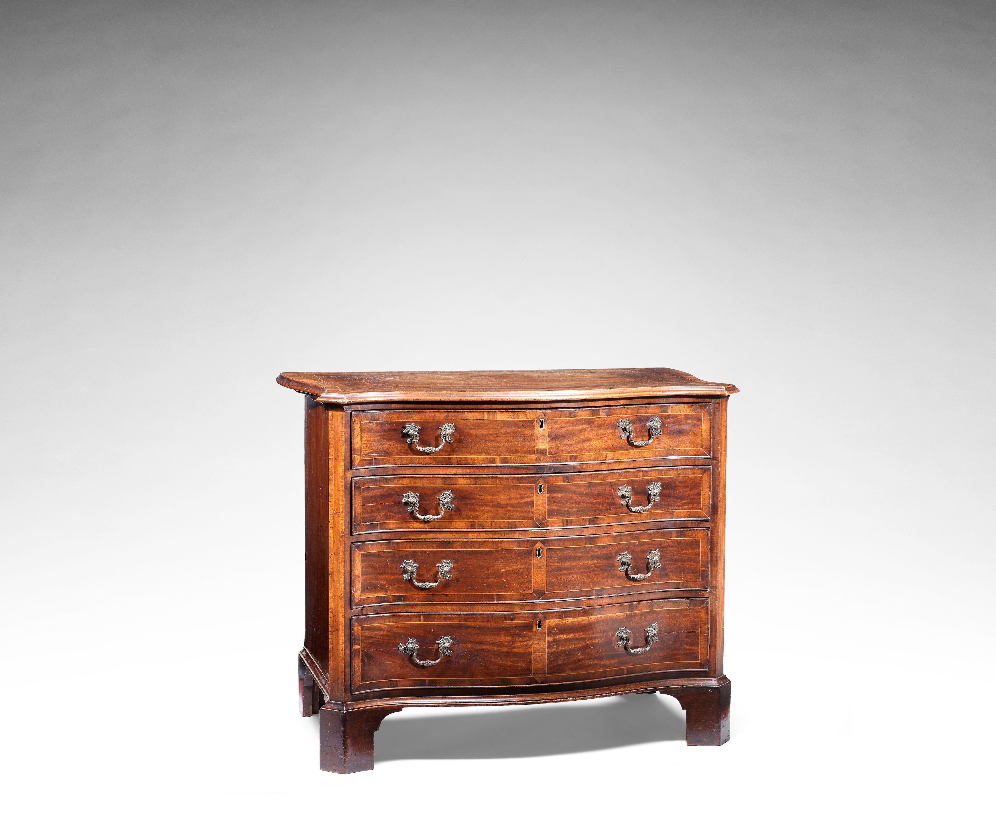 Bonhams : George III mahogany and goncalo alves banded serpentine chest ...