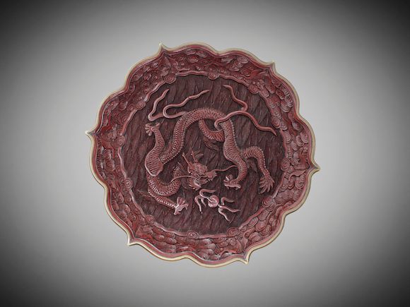 Bonhams : A Chinese carved cinnabar 'dragon' plate Qianlong six ...