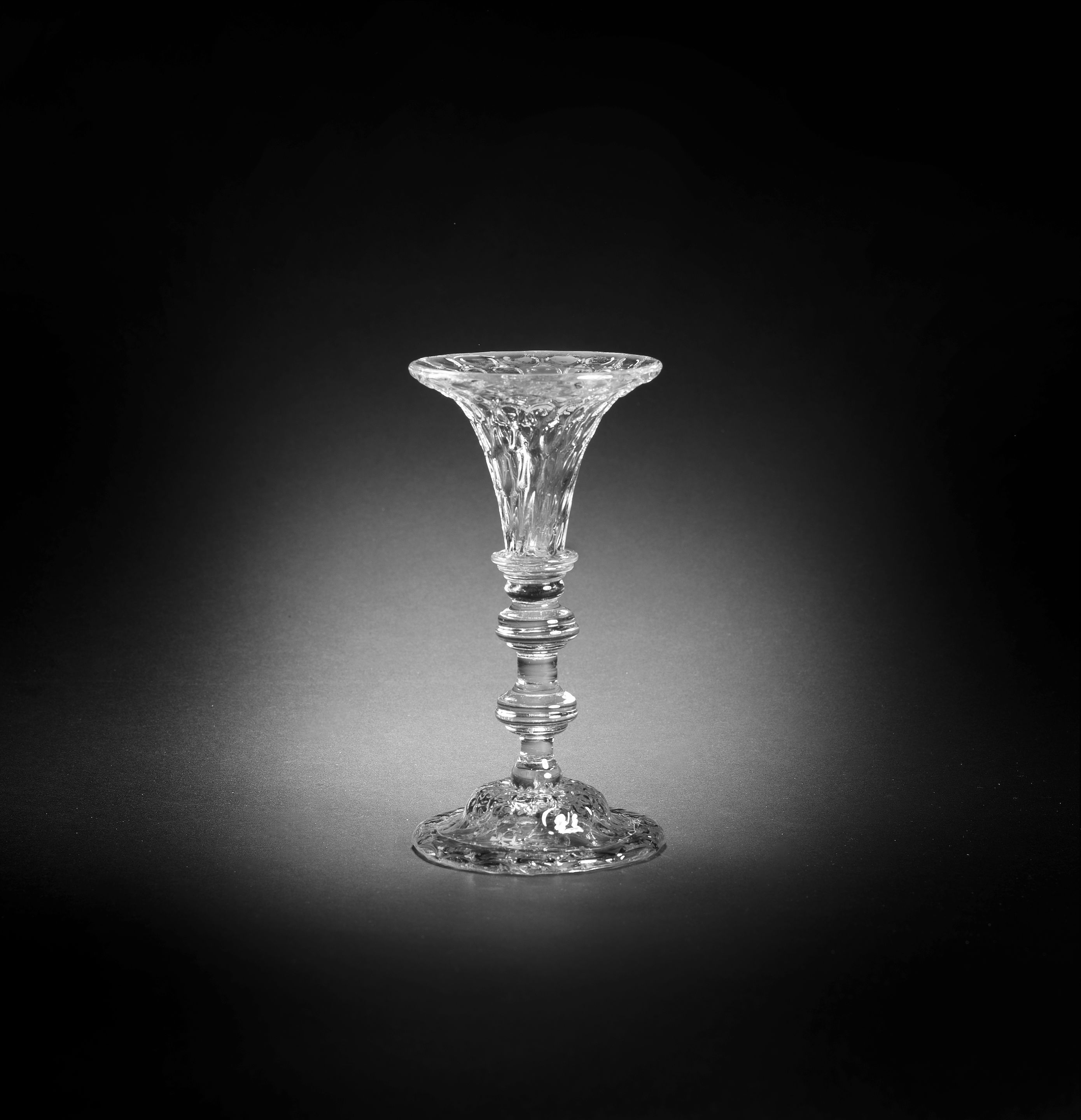 Bonhams : A rare moulded baluster wine glass, circa 1740
