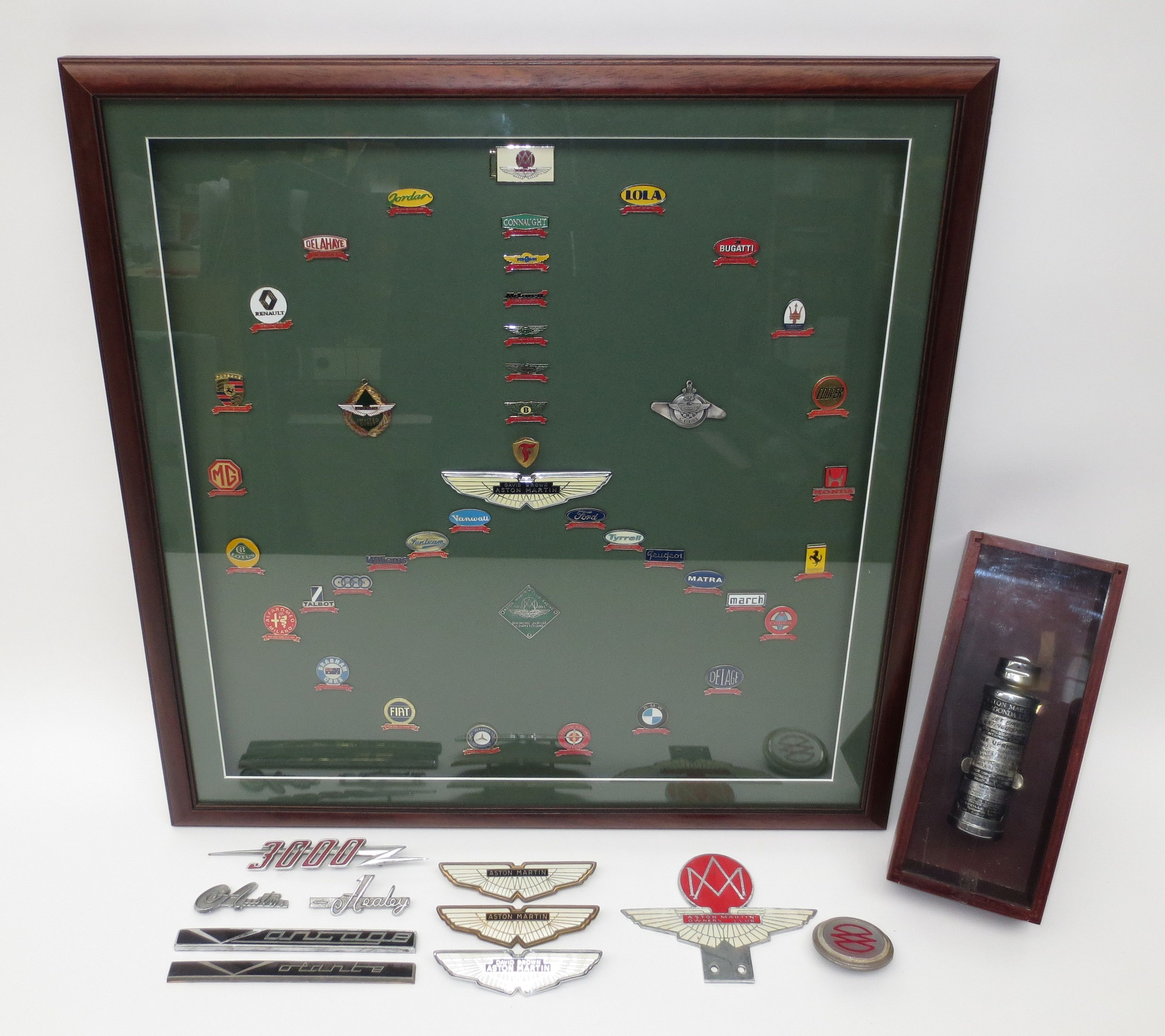 Bonhams Cars : A framed display and loose badges including Aston Martin ...