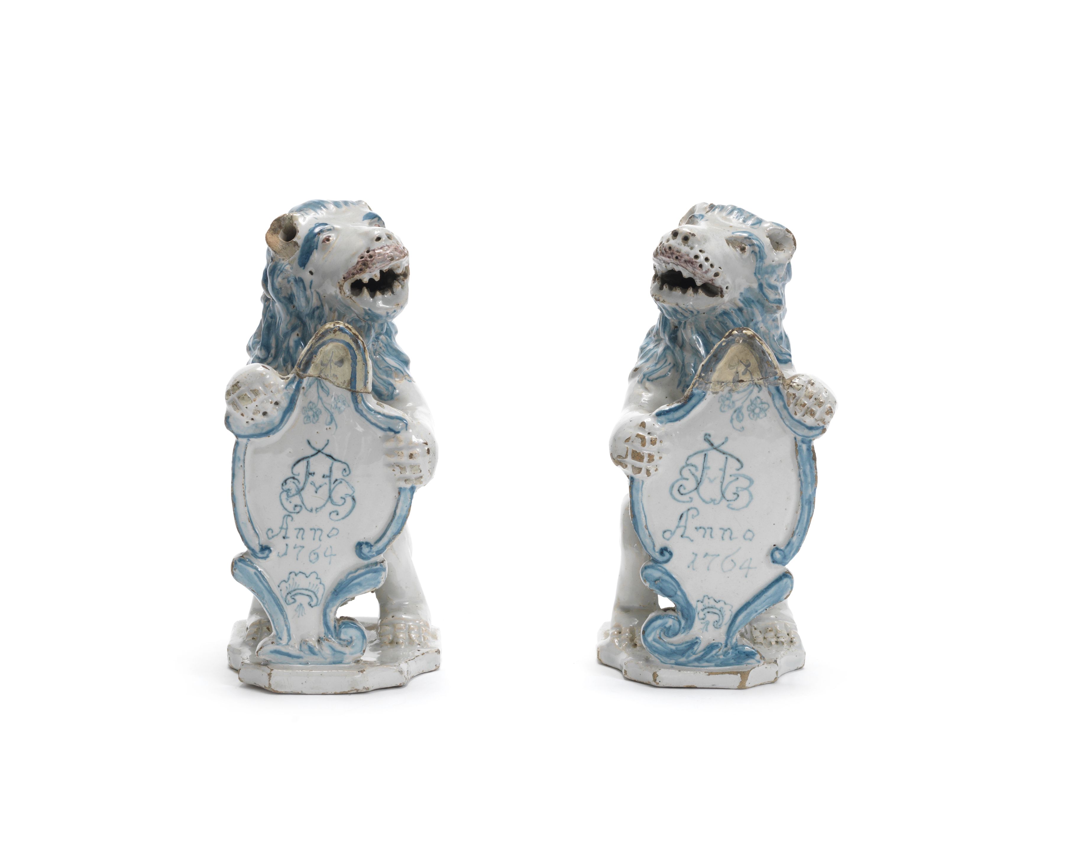 Bonhams : A pair of German faience models of lions supporting shields ...