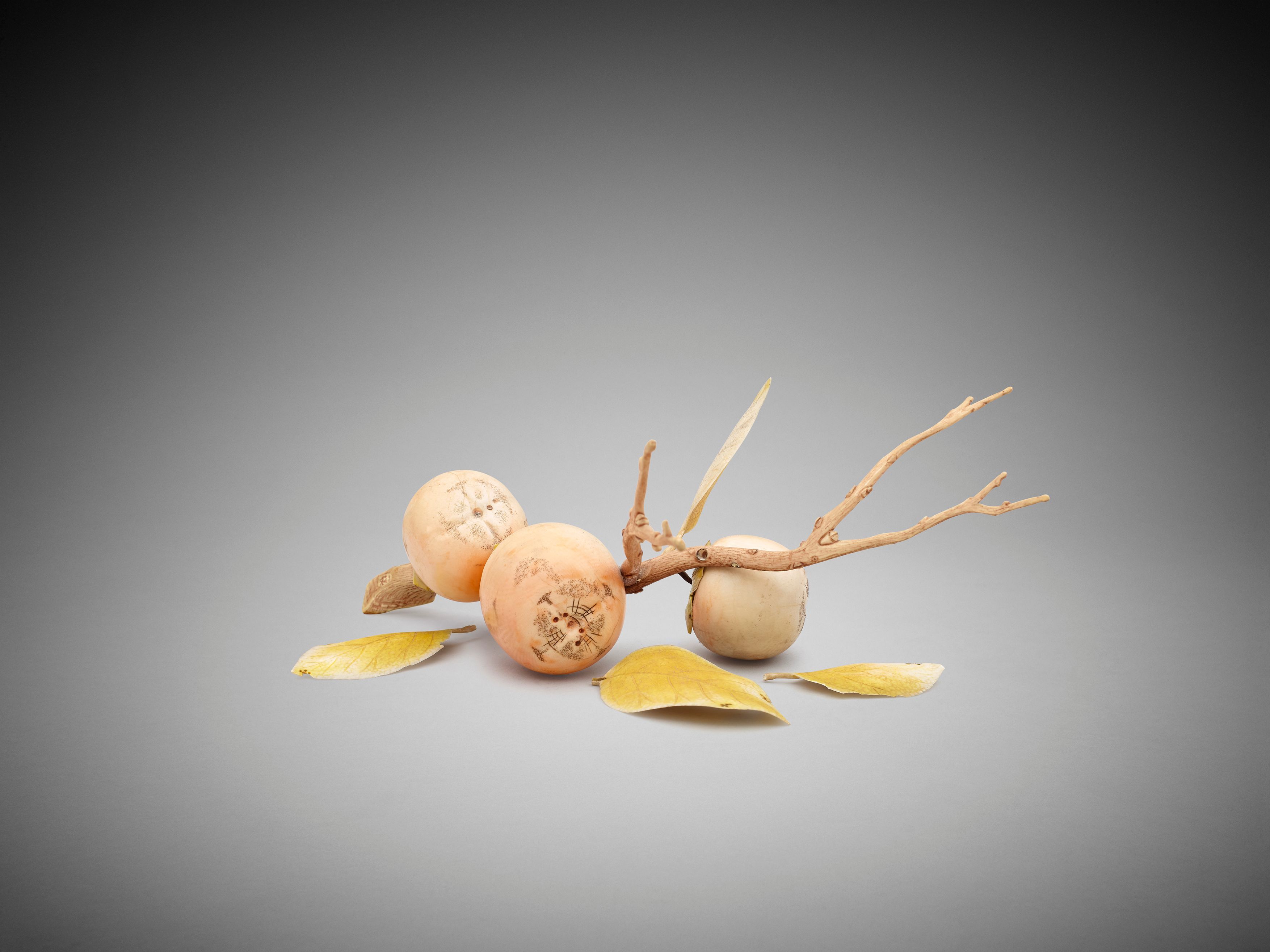 Bonhams : A Japanese stained ivory okimono of a branch of persimmon ...