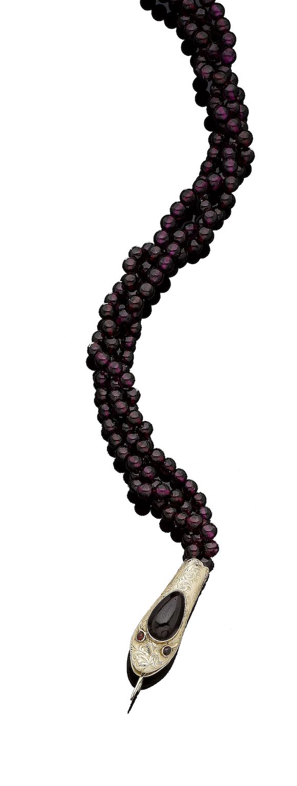 Bonhams : A triple-strand garnet bead necklace with snake head clasp