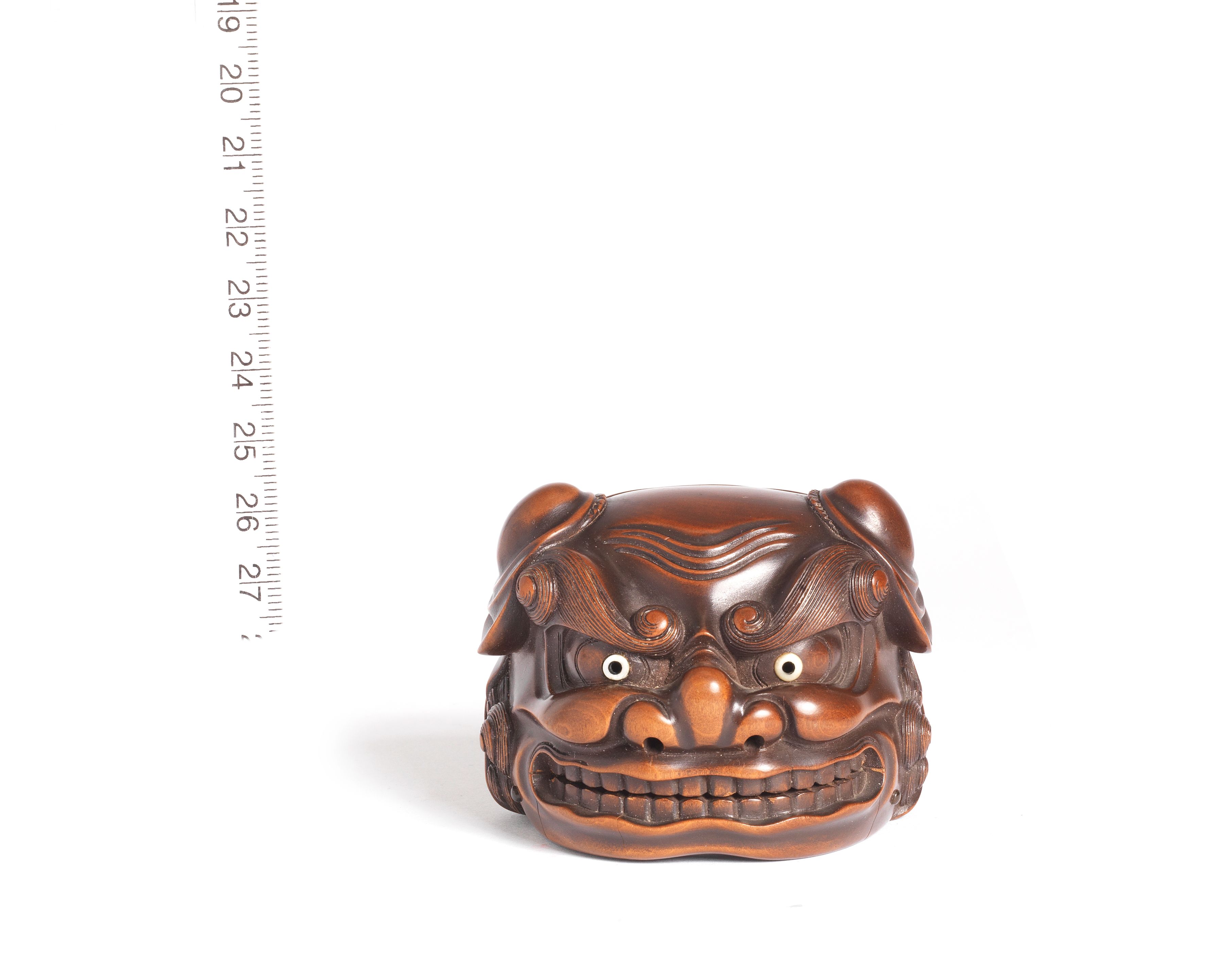 Bonhams : A large wood netsuke in the form of a shishi mask and cloak ...