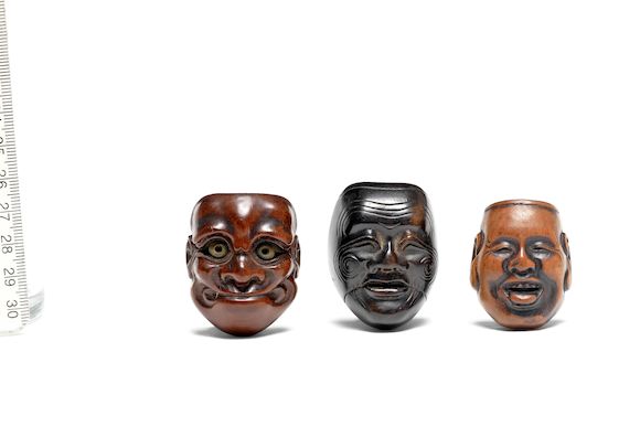 Bonhams : Three wood mask netsuke By members of the Deme family, early ...