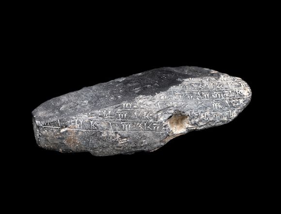 Bonhams : An Achaemenid grey stone inscribed column base fragment