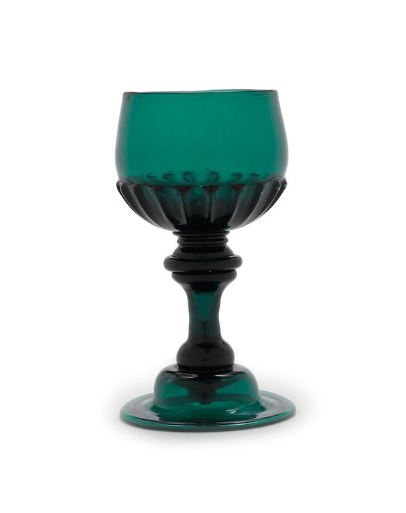 Bonhams : A rare Emerald green baluster mead or champagne glass, circa 1730-40