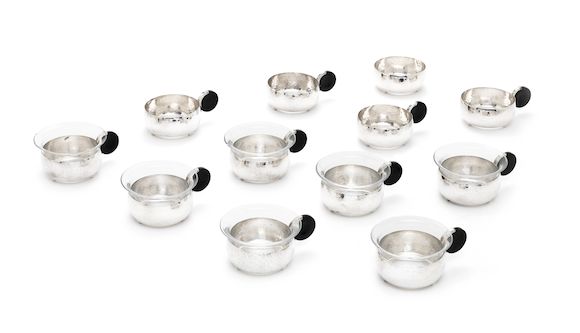 Bonhams : A set of twelve Arts and Crafts German silver tea cup holders ...