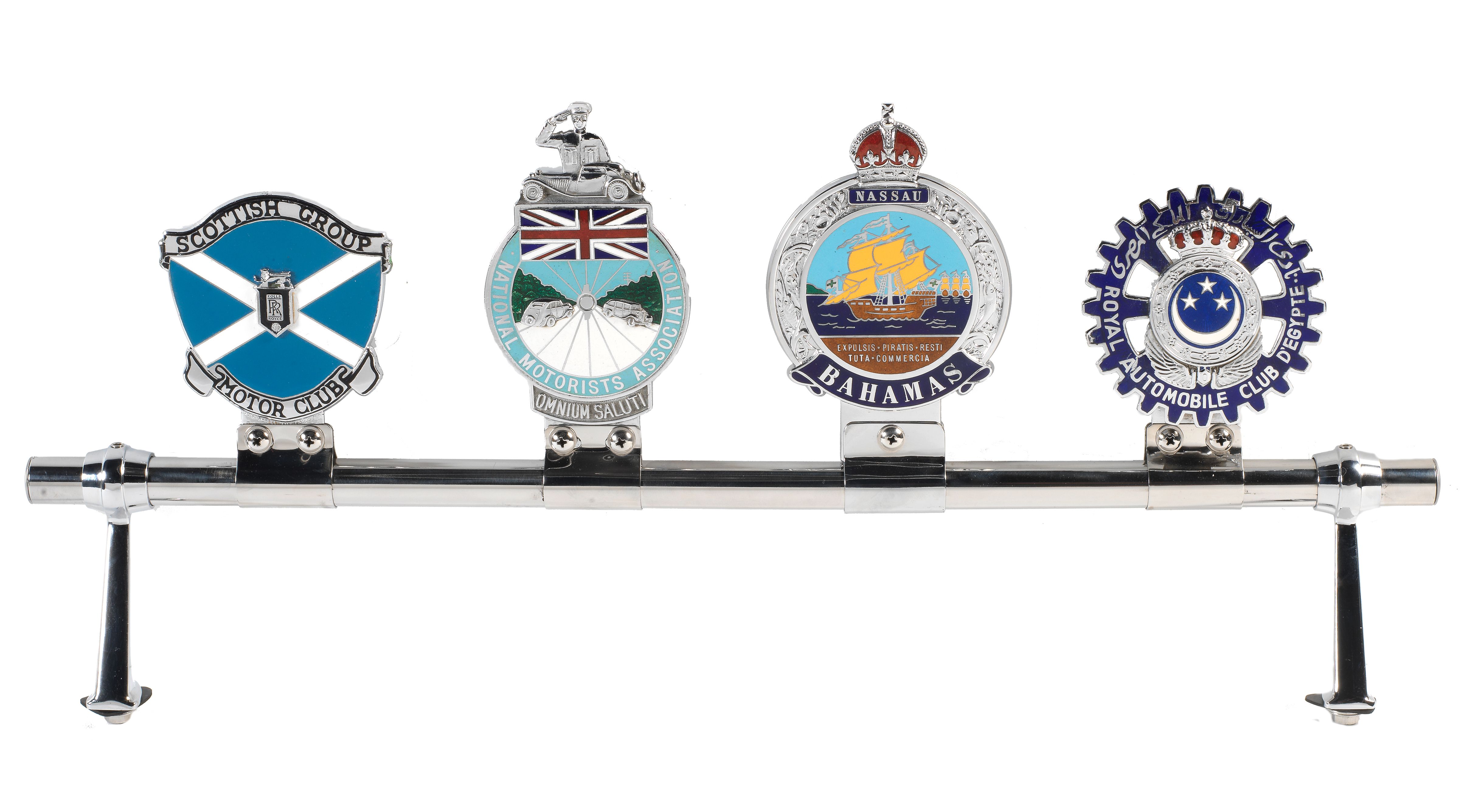 Bonhams Cars : A badge bar fitted with four enamel motoring badges,