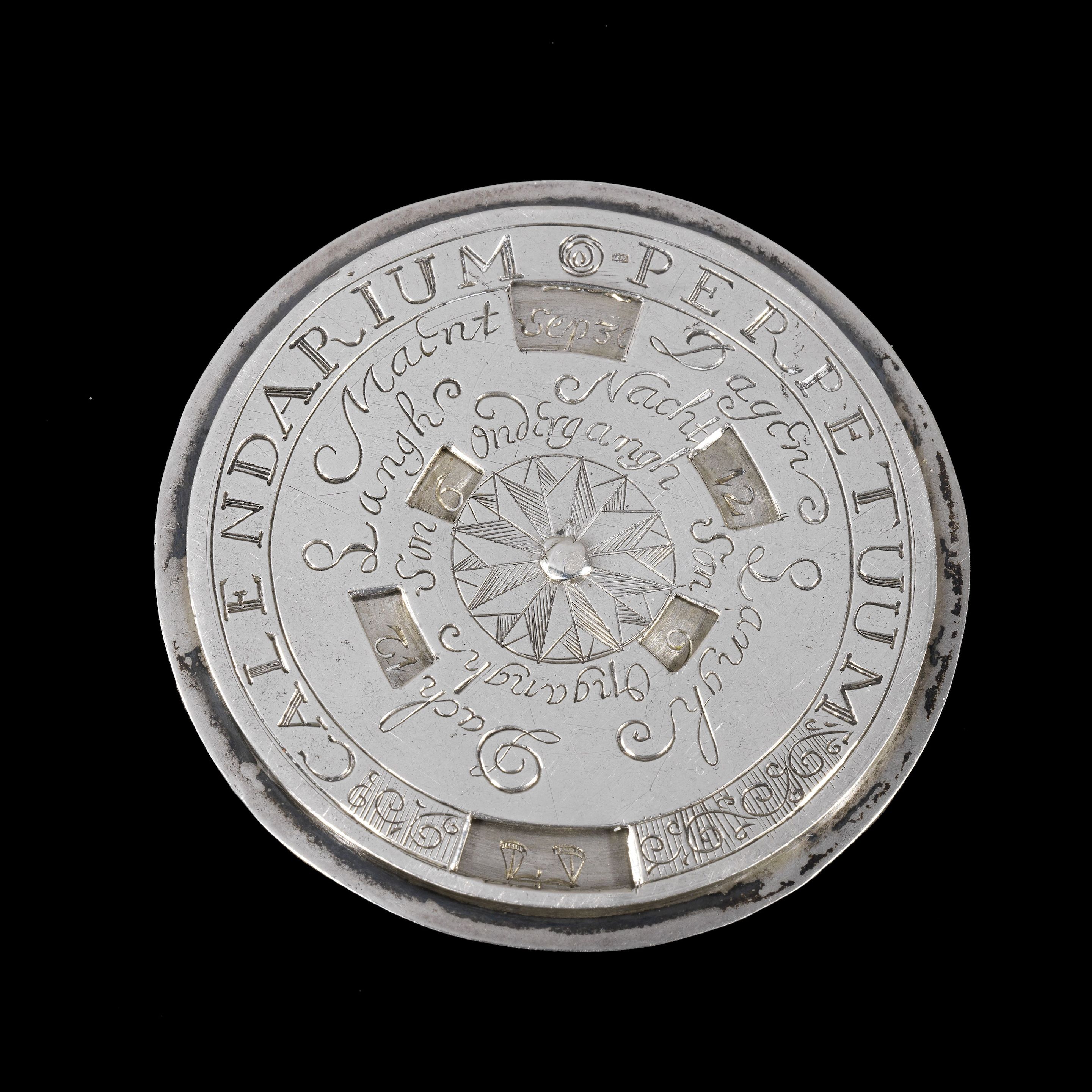 Bonhams : A 17th century silver perpetual calendar disc