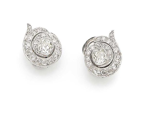 Bonhams : A pair of diamond scroll earclips,