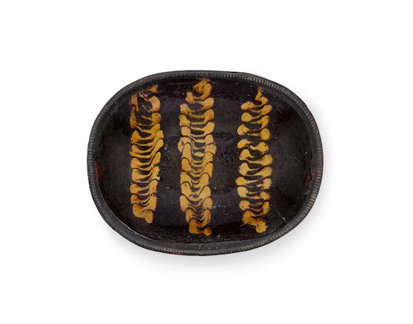 Bonhams : A large slipware dish, 18th century,