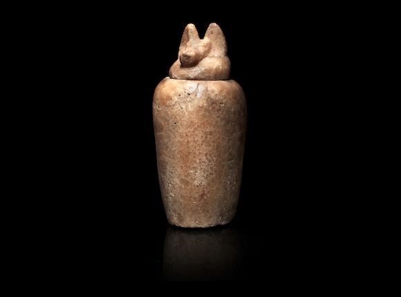 Bonhams : An Egyptian alabaster canopic jar of Duamutef