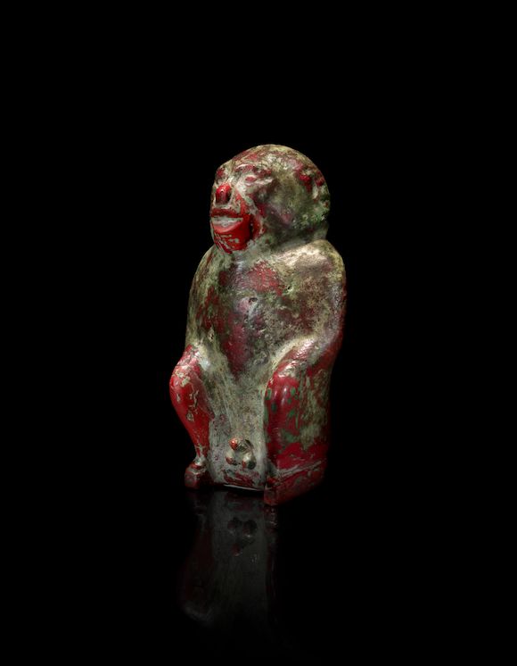 Bonhams : An Egyptian red glass figure of a baboon