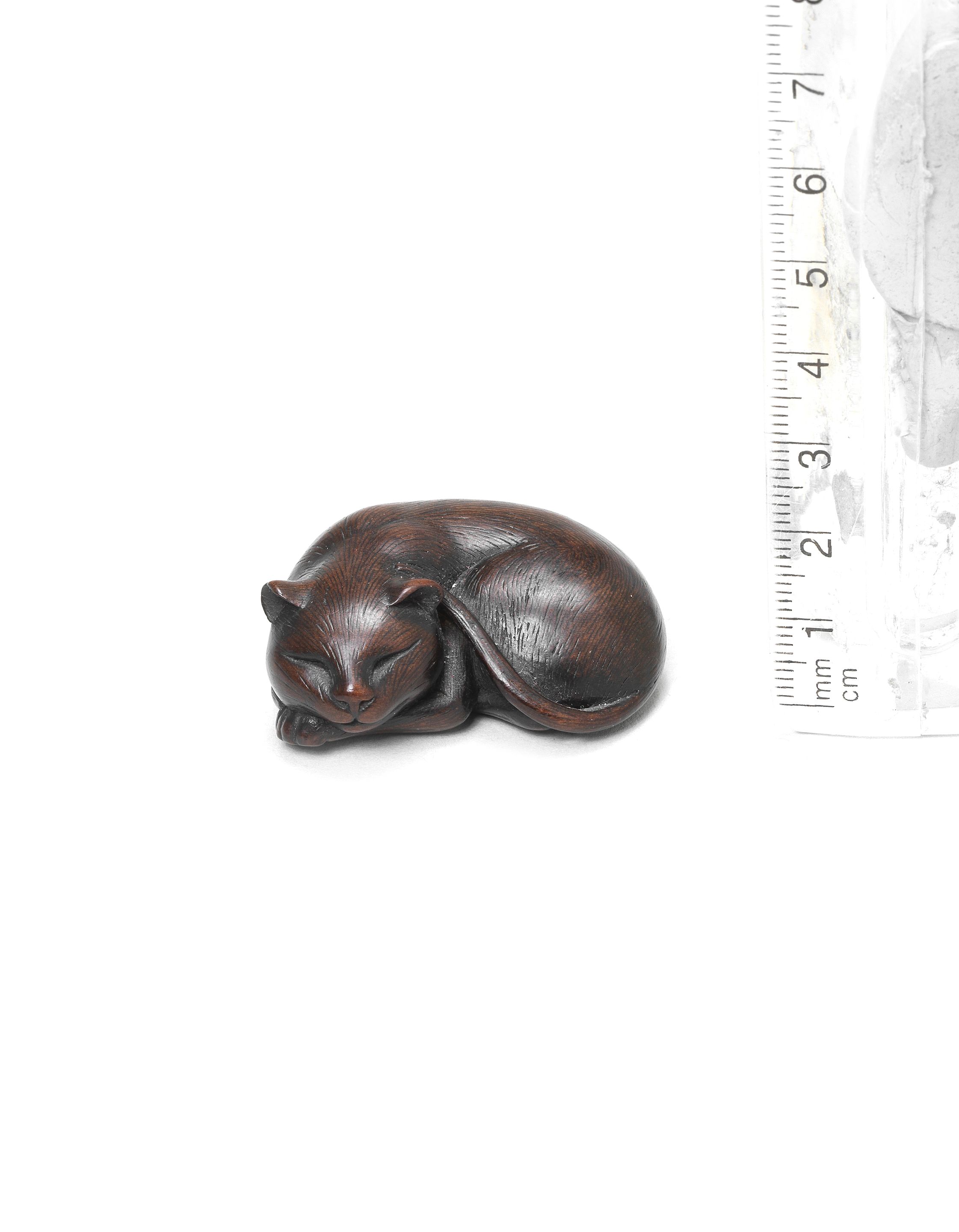 Bonhams : A wood netsuke of a cat By Issen, early 19th century
