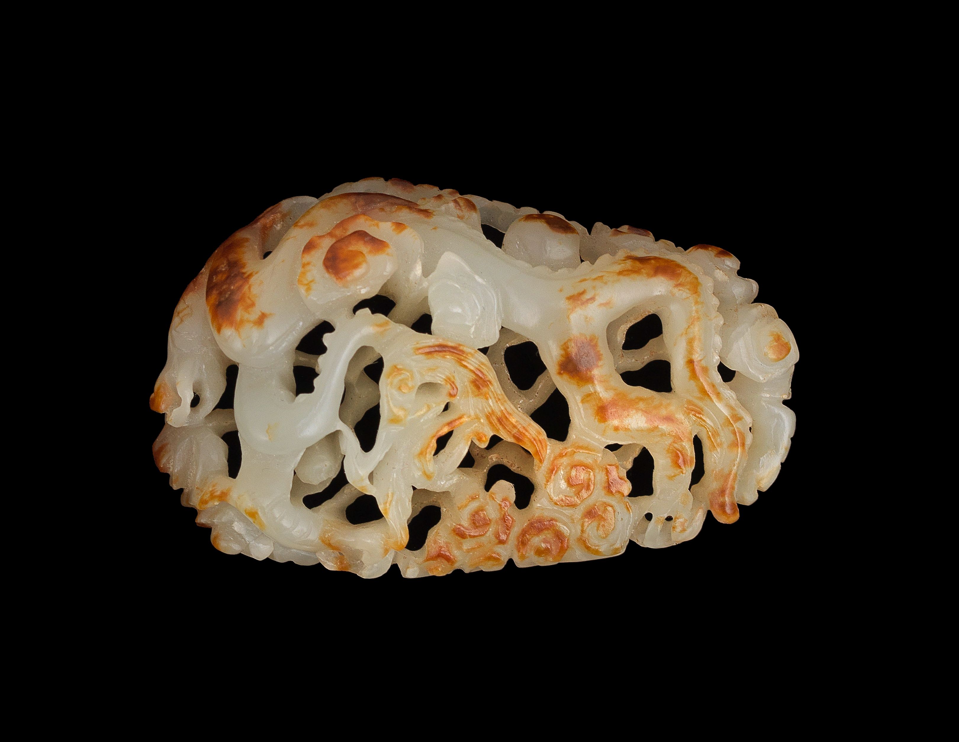 Bonhams : A rare white and russet jade reticulated dragon plaque Yuan ...