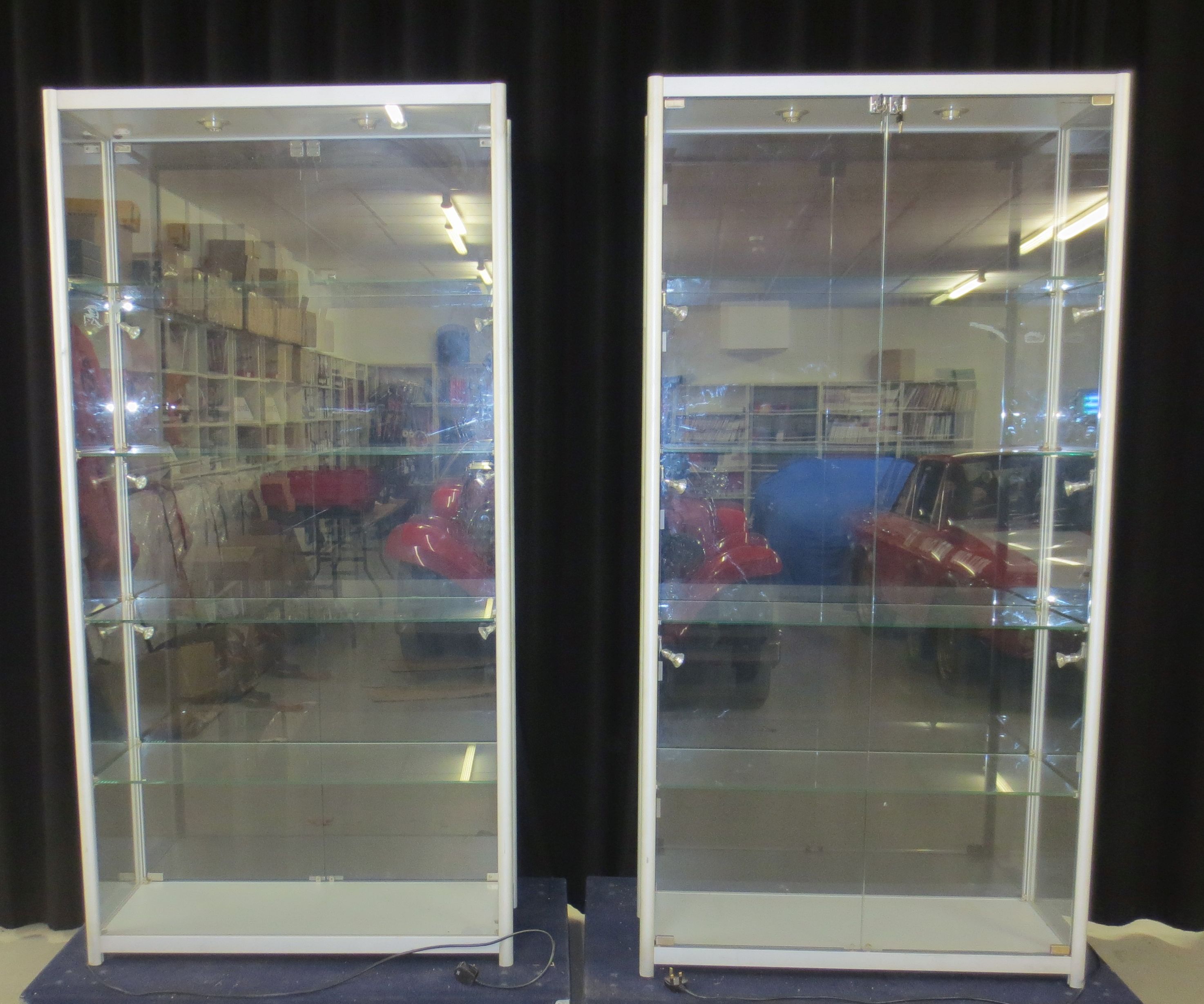 Bonhams Cars : Two glazed upright display cabinets,