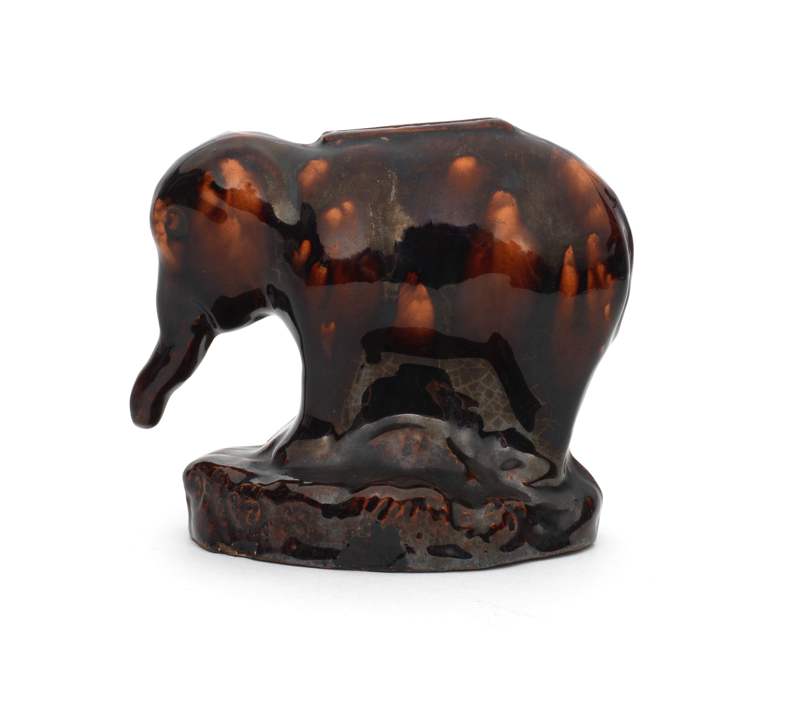 Bonhams : A Treacle-glazed elephant money box, early 19th century