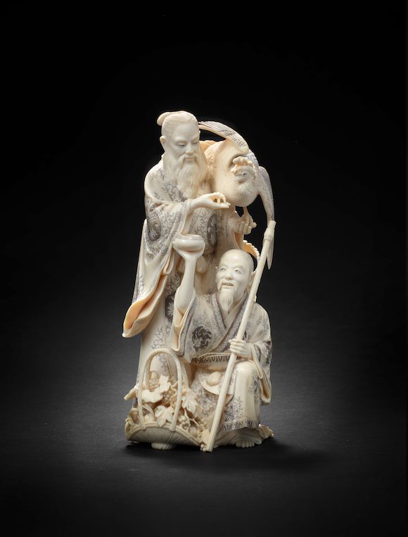 Bonhams : An ivory okimono figure group of two Chinese Immortals with a ...