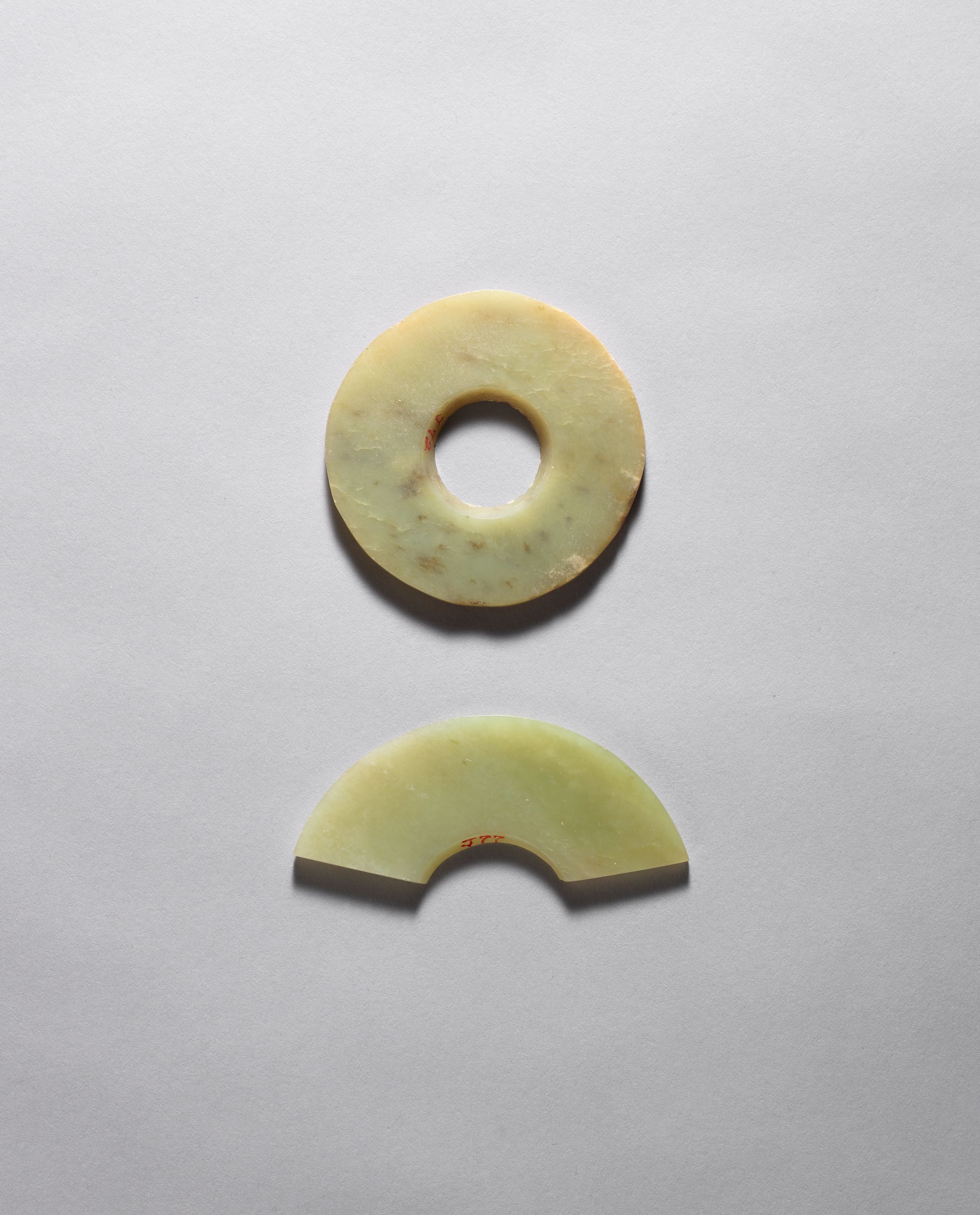 Bonhams : A yellow-green jade disc, bi, and a yellow jade pendant ...