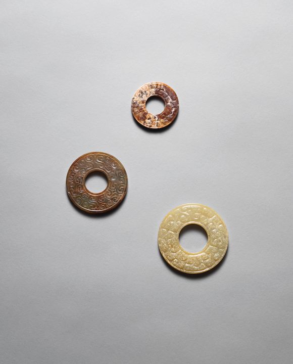 Bonhams : Three small jade 'dragon' discs, bi Eastern Zhou Dynasty (3)