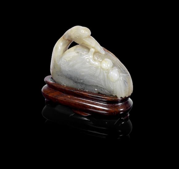 Bonhams : A pale green and russet jade 'crane and peach' group Ming Dynasty