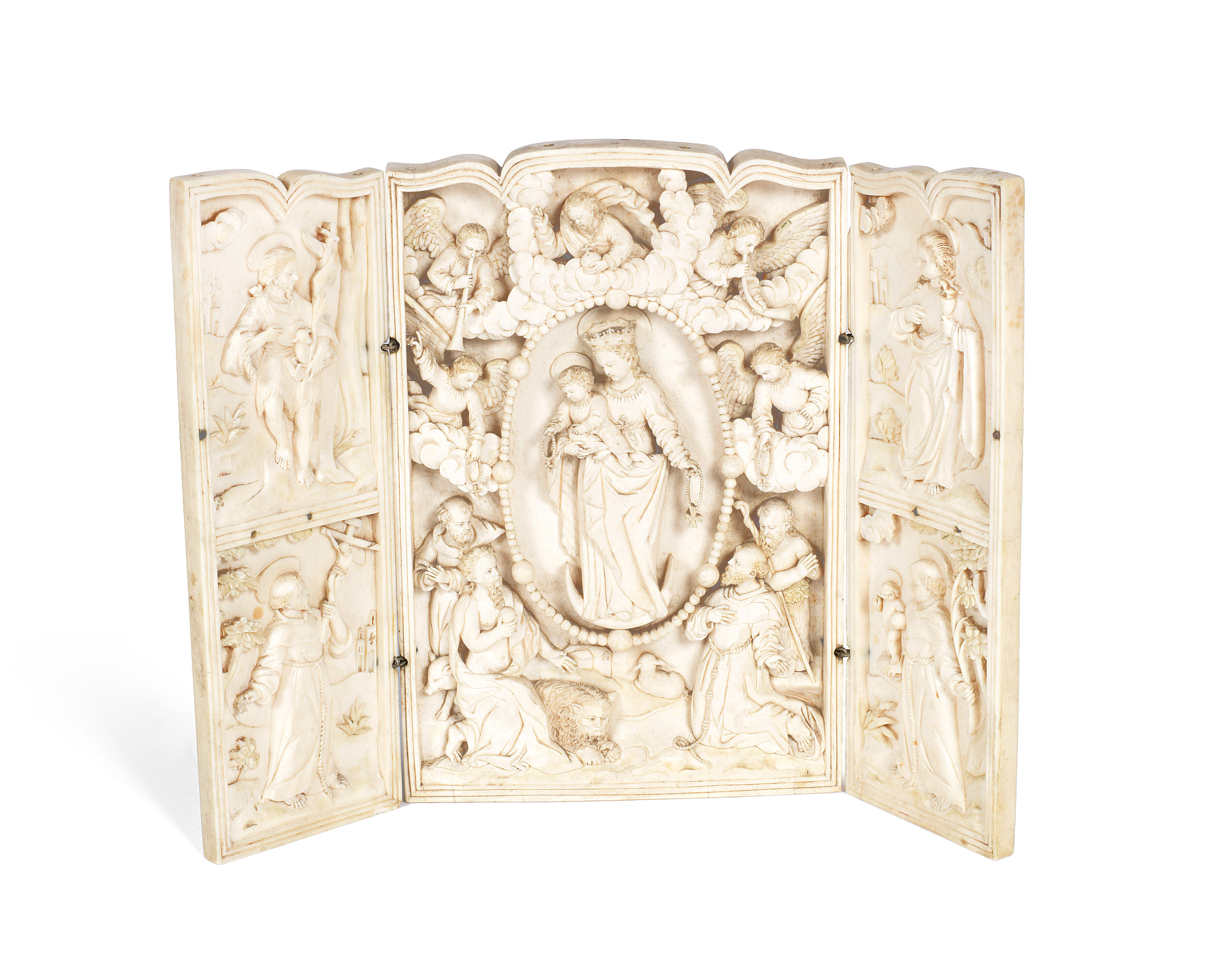 An 18th century carved ivory portable triptych depicting the Madonna of the Rosary and the ...