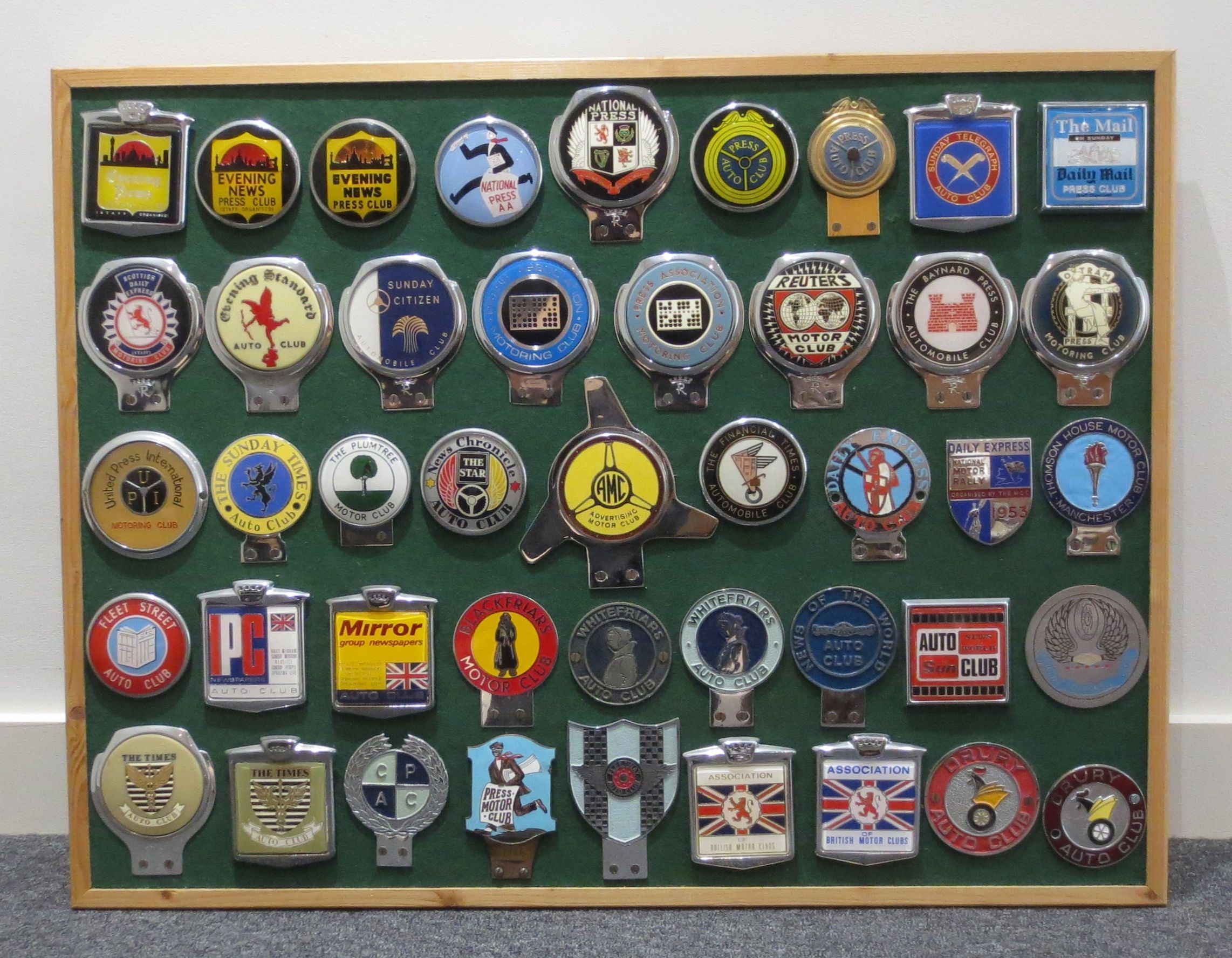 Bonhams Cars : A framed display of Motoring Press Club car badges,