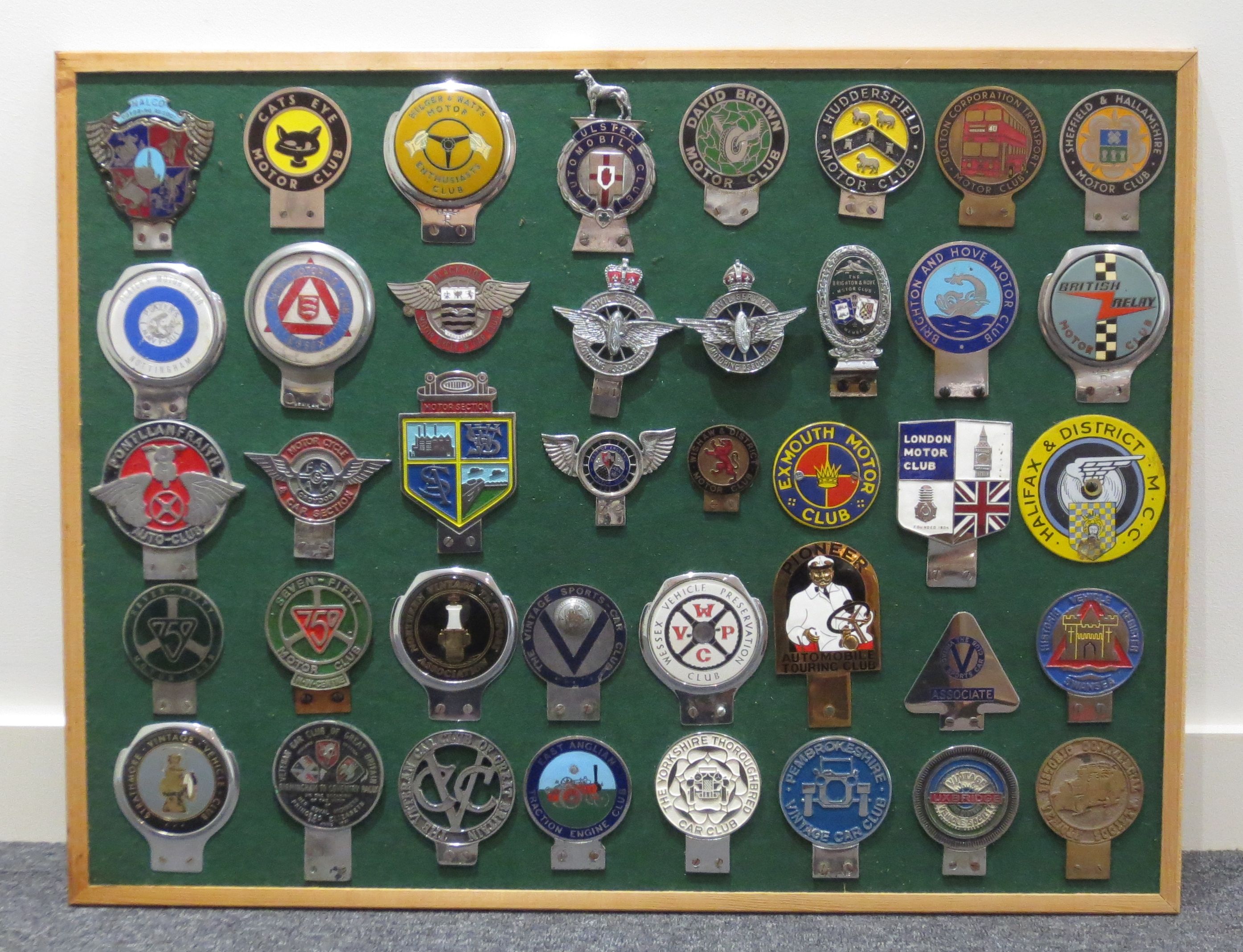 Bonhams Cars : A framed display of British Motor Club car badges,