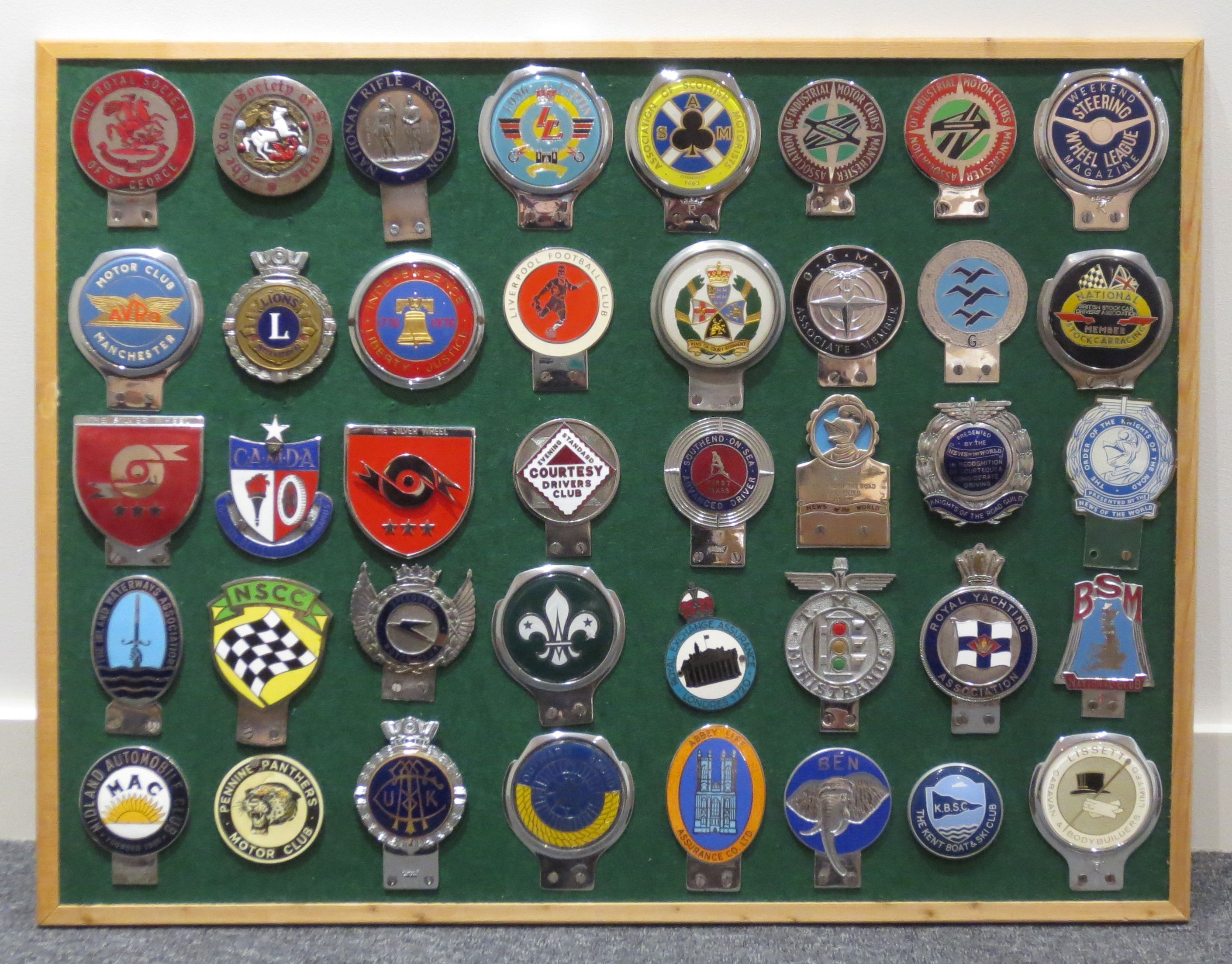 Bonhams Cars : A framed display of British car badges,