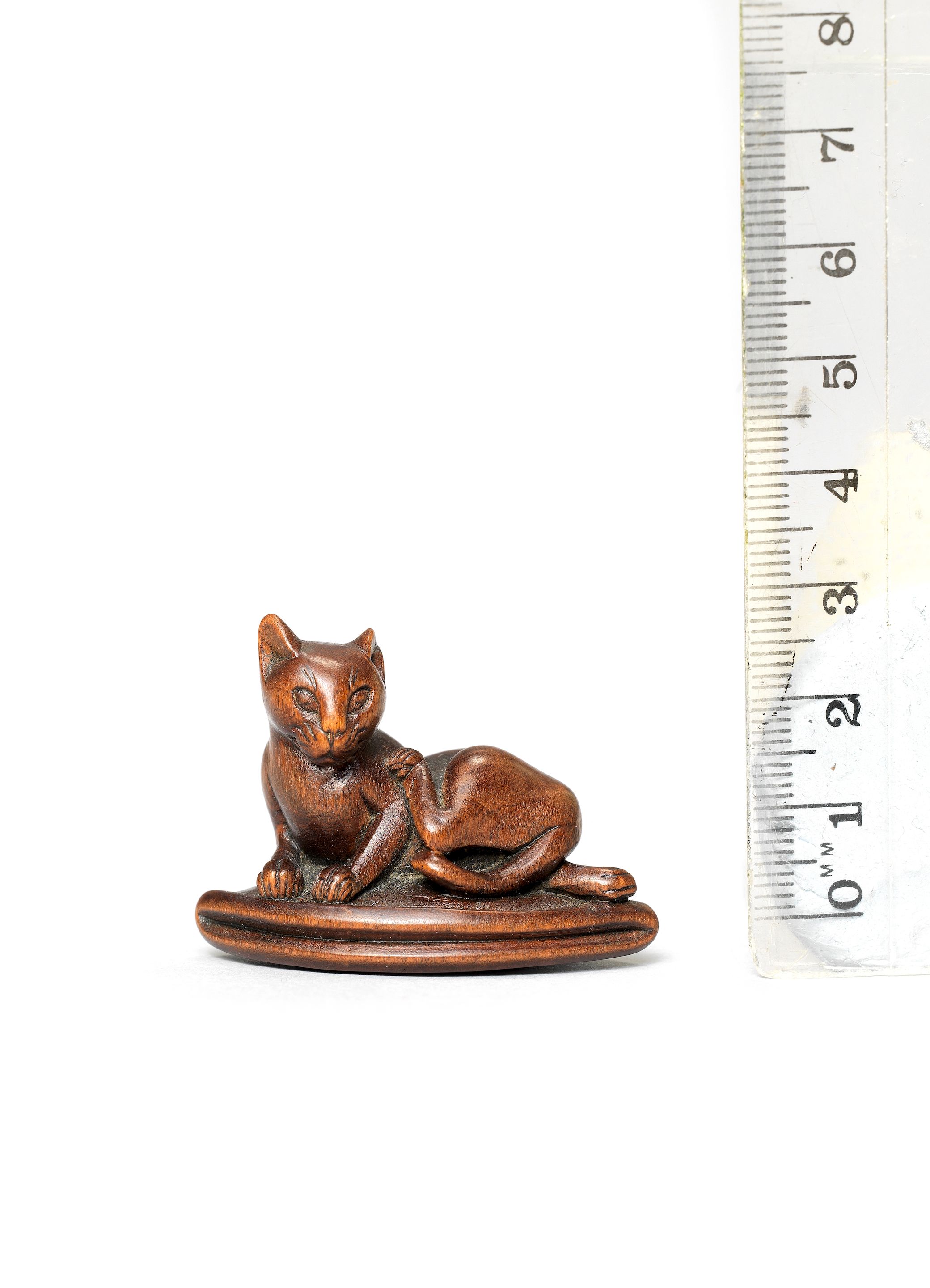 Bonhams : A small wood netsuke of a cat Early 19th century