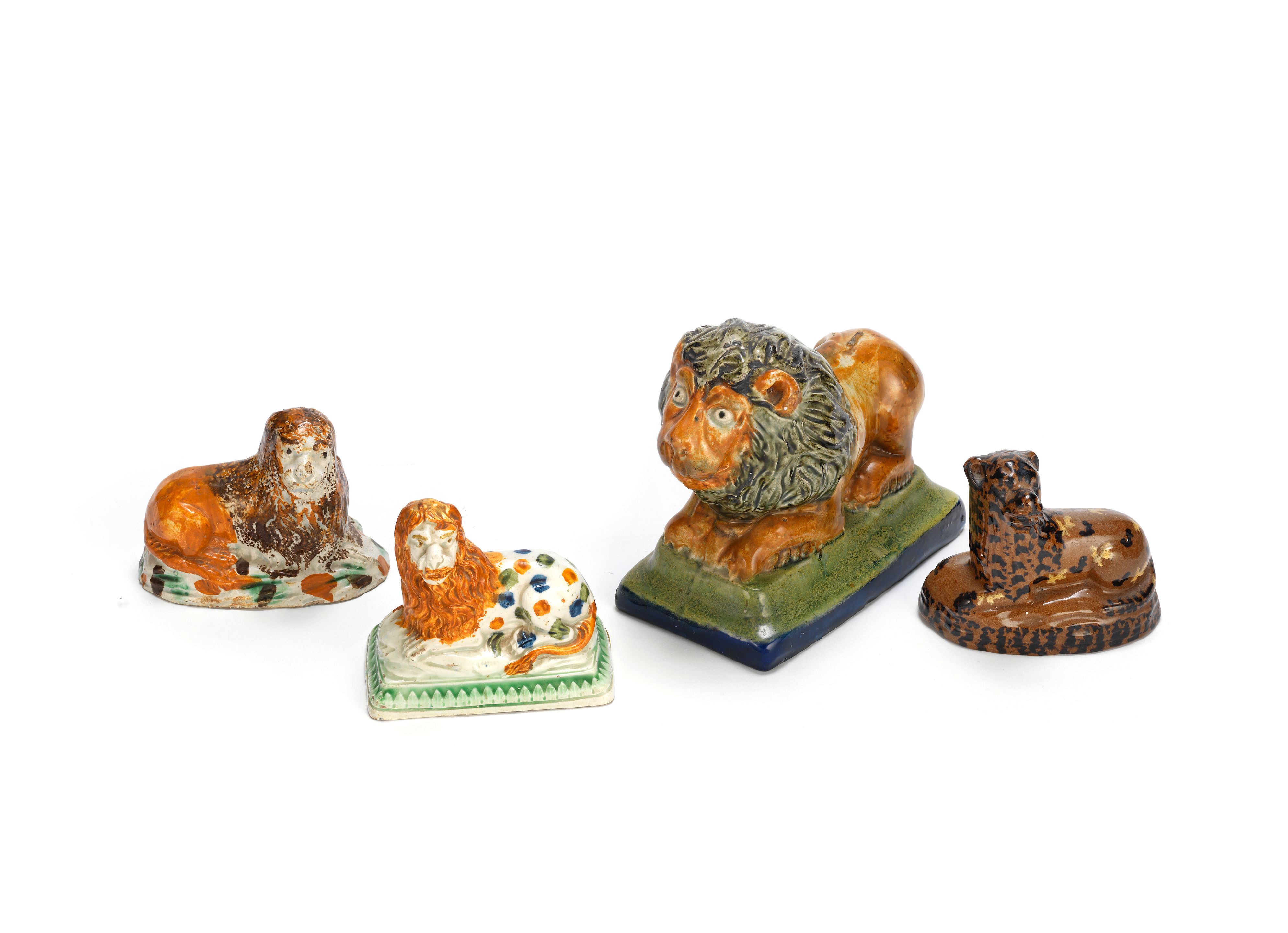 Three Prattware lion models and a Bovey Tracey lion, circa 1800-10 ...